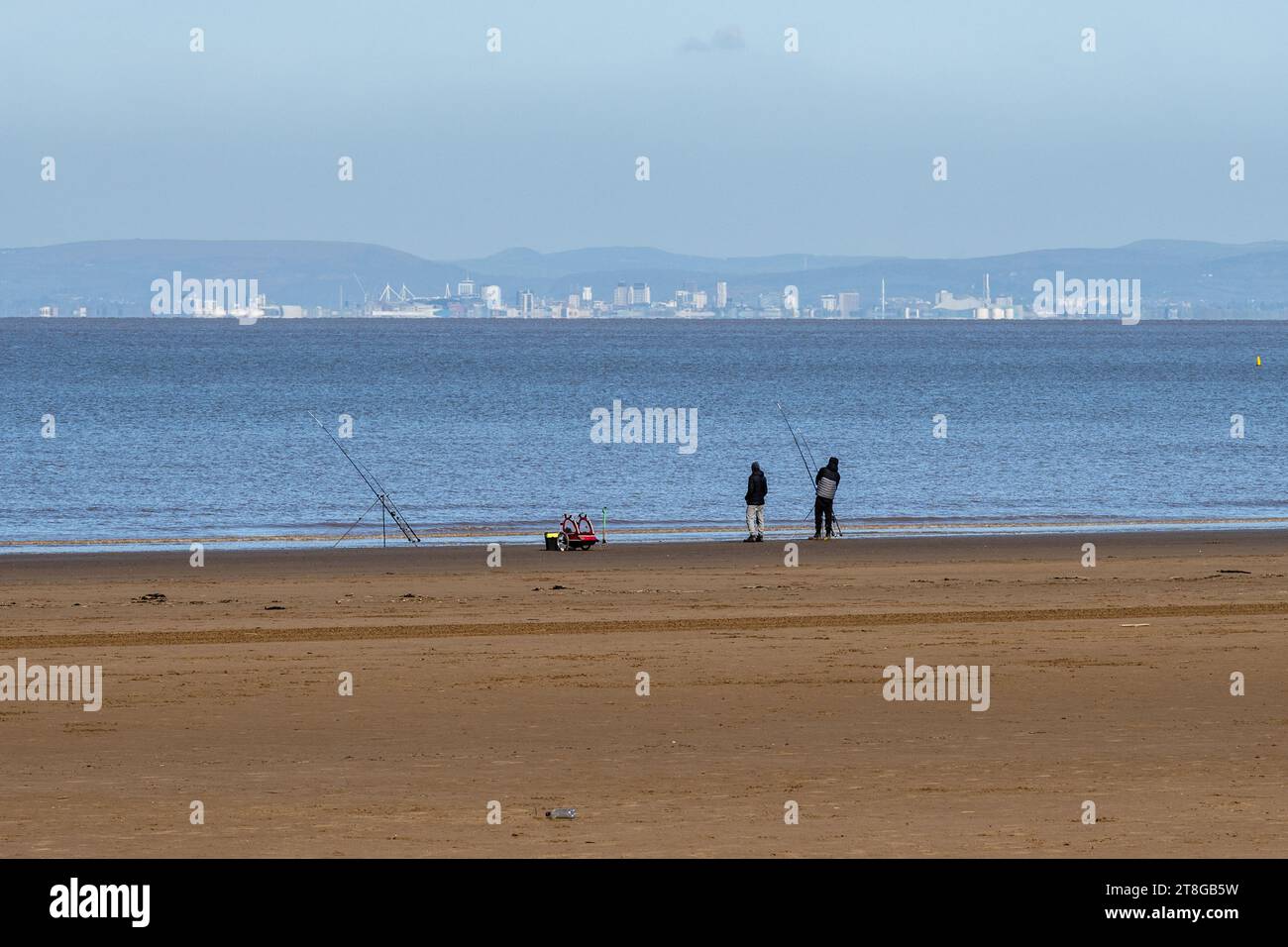People fish on the shore of the Bristol Channel at Weston-Super-Mare in ...