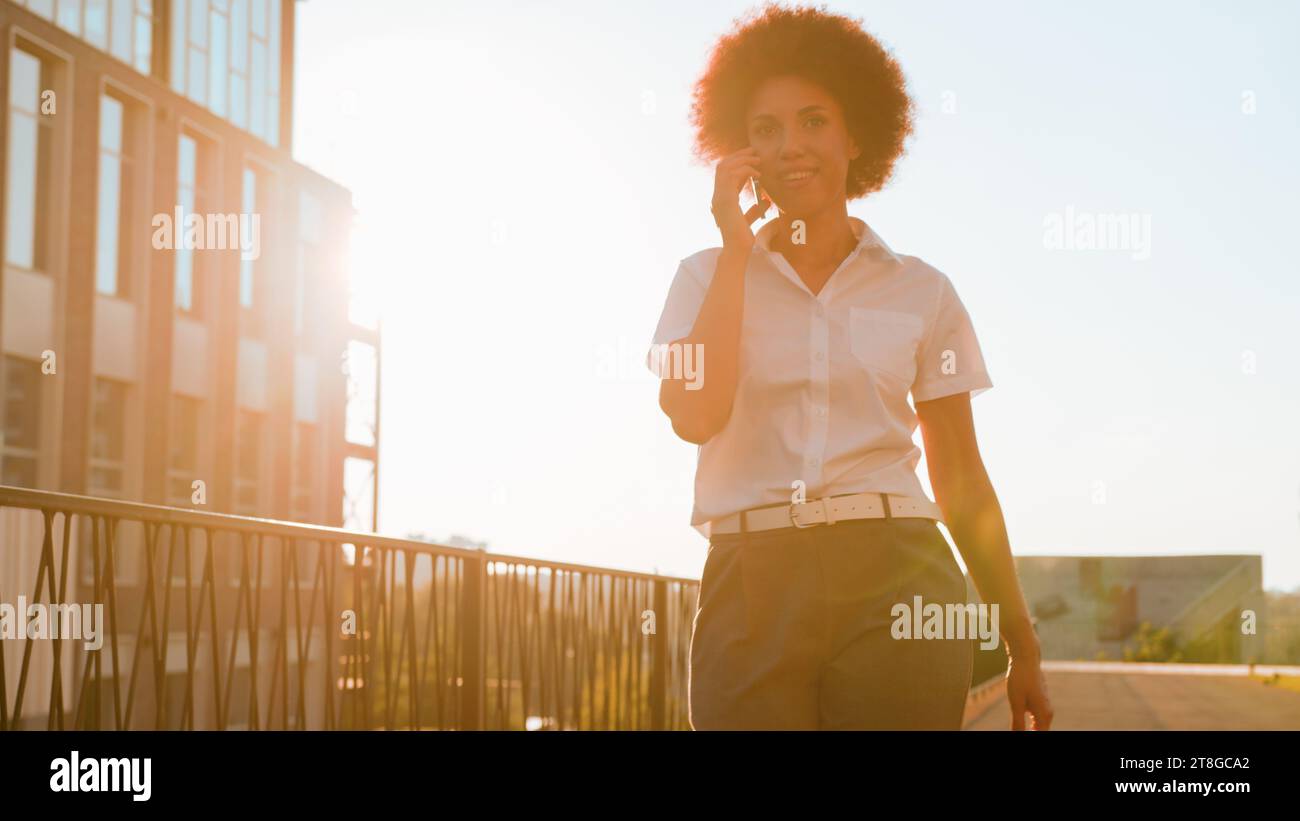 Female African American girl in city business woman talking mobile ...