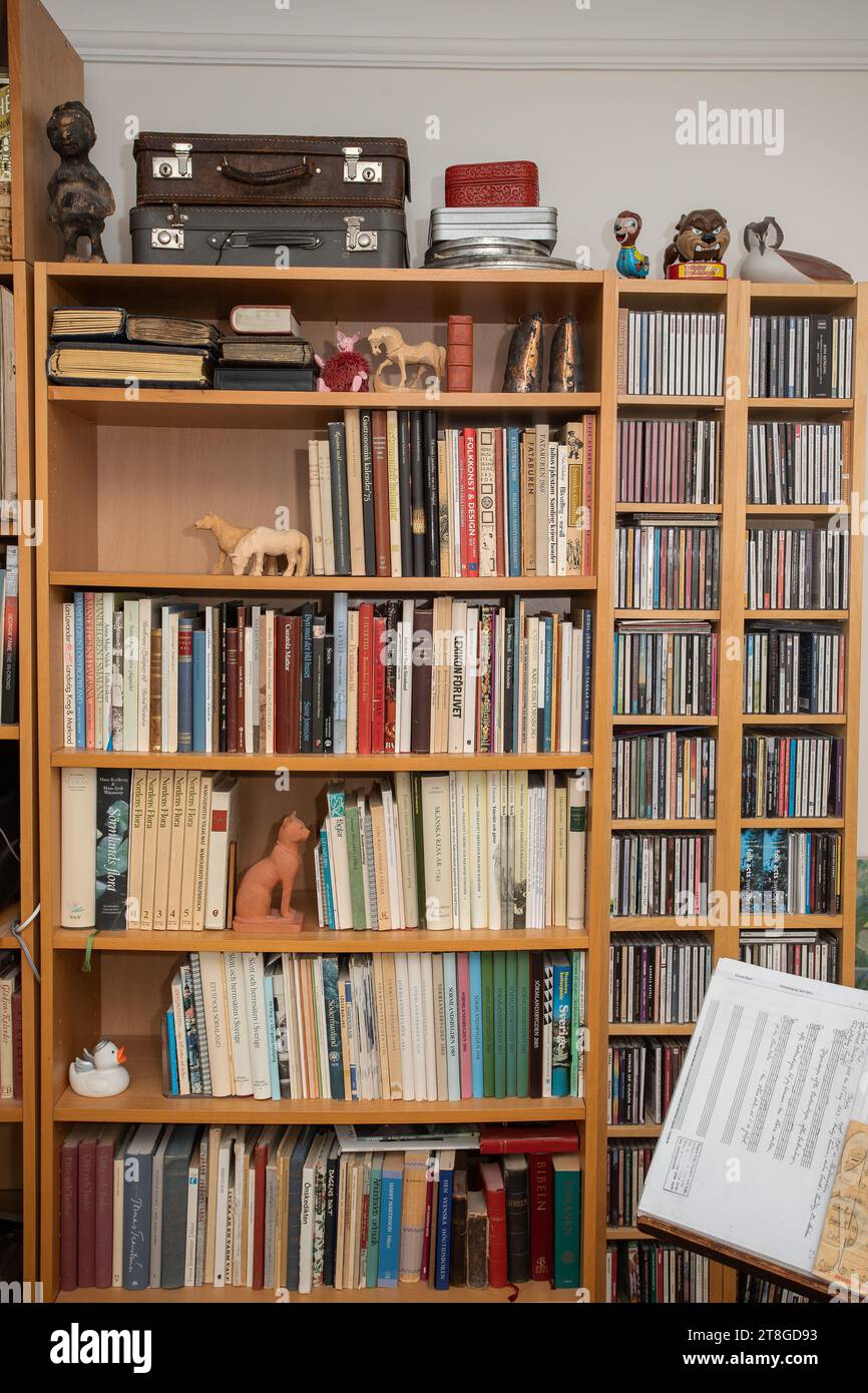 Bookshelves in homes library rarely contain only books Stock Photo - Alamy