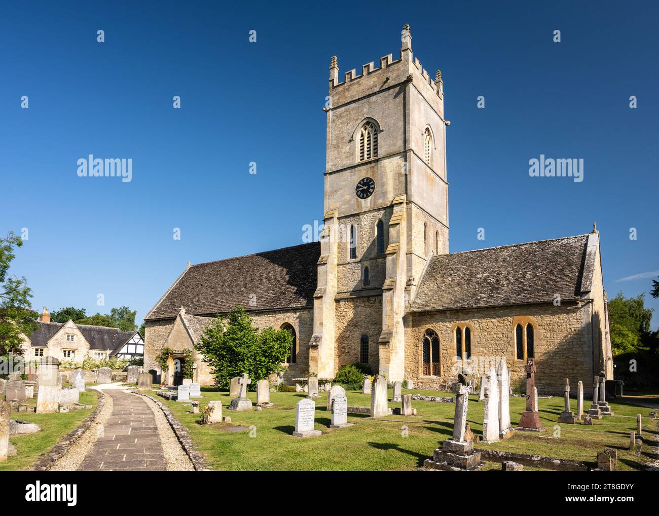 Sun shines on the traditional English parish church of St John the ...