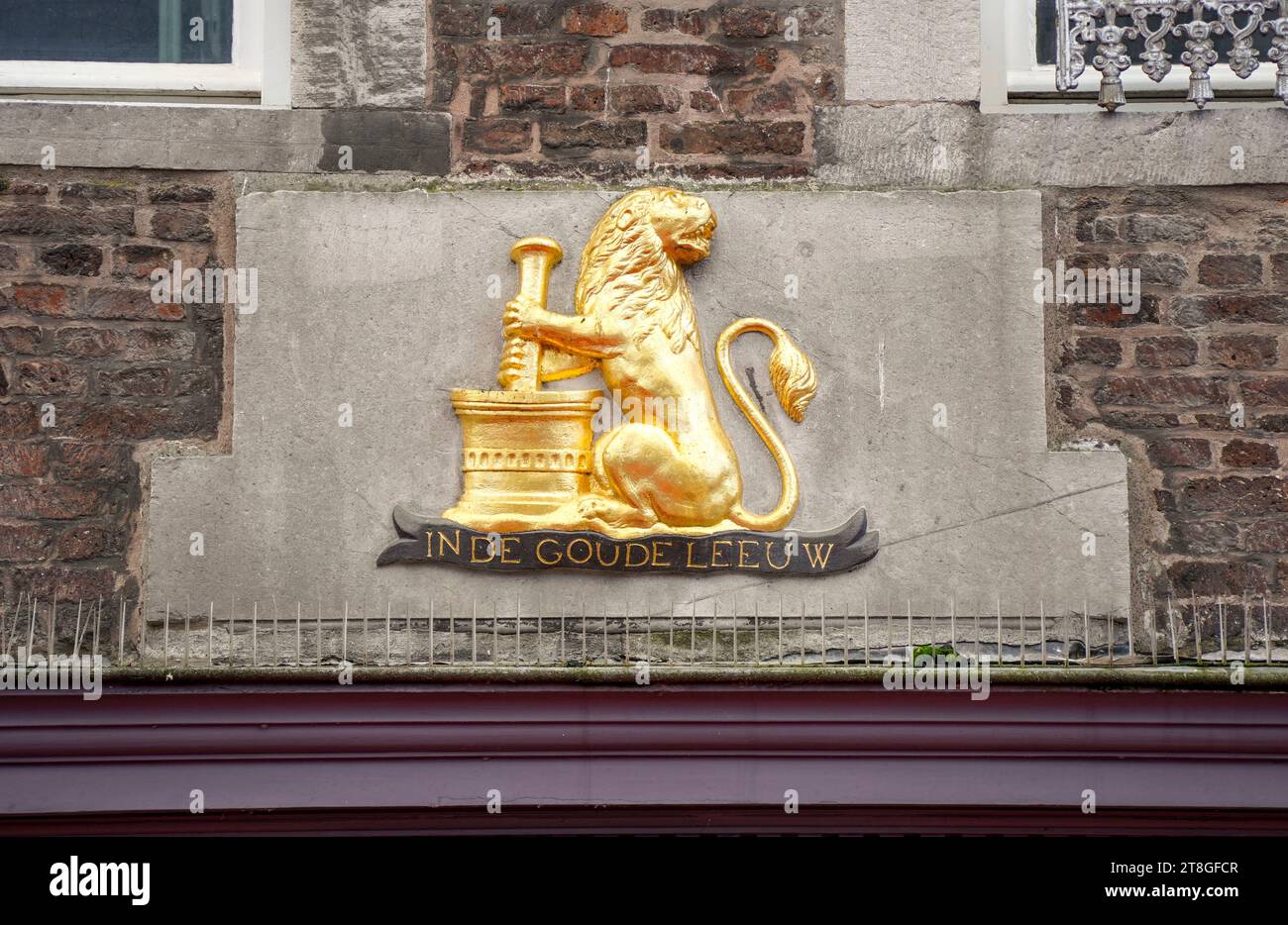 Gable stones, plaque depicting In the Golden Lion on old building ...