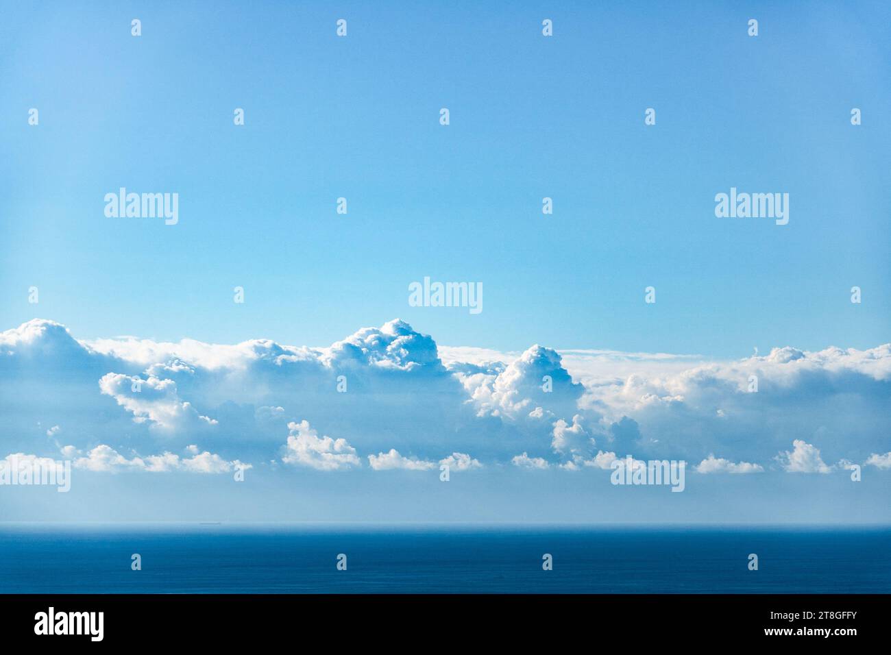a view of white fluffy clouds and blue skies along the horizon of the ...