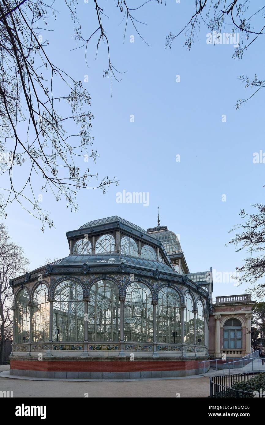 Victorian glass pavilion in a park at dusk, reflecting the twilight ...