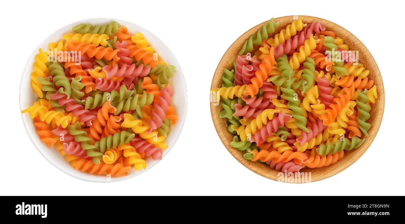 raw Fusilli colored pasta in bowl isolated on white background with ...