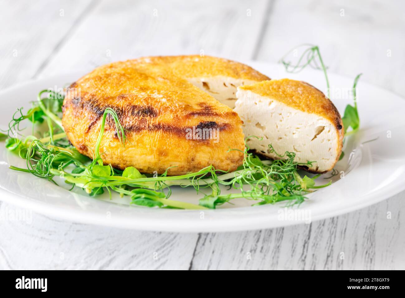 Baked Ricotta cheese wheel glazed with egg Stock Photo - Alamy