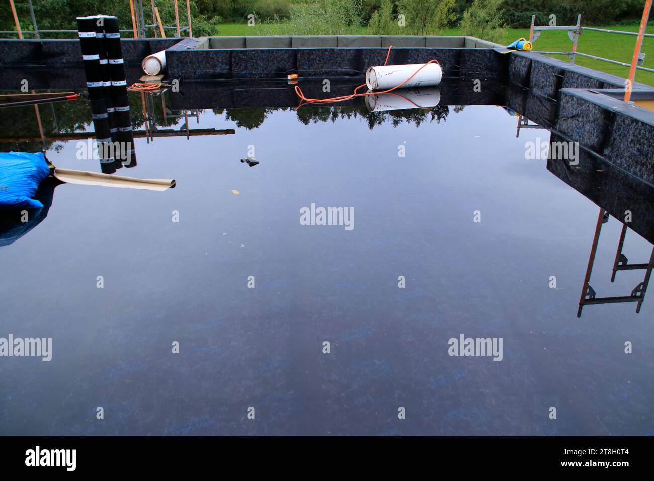 Gas bottle lies on a house roof that is under water Stock Photo - Alamy