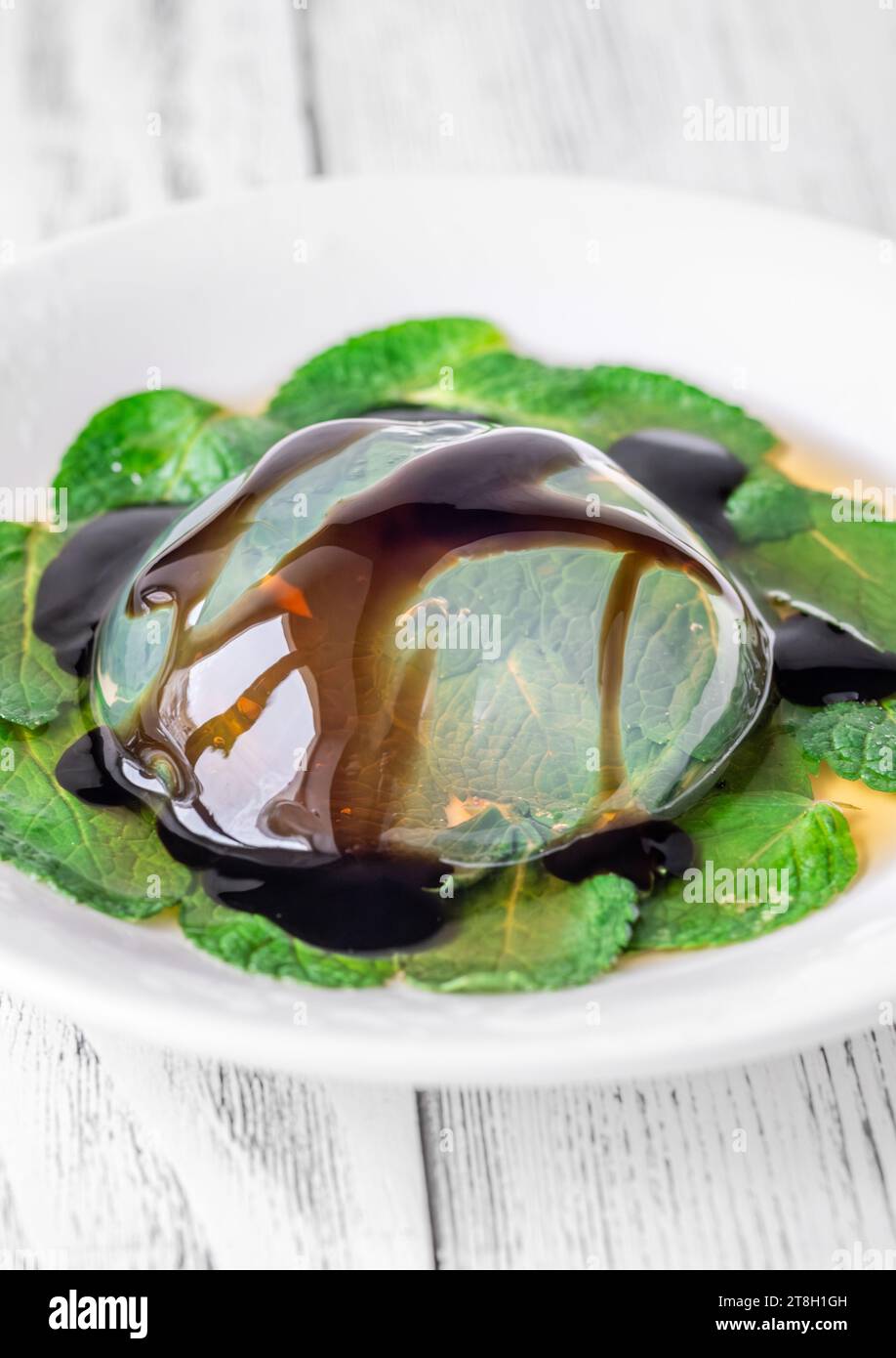 Portion of raindrop cake on mint leaves bad Stock Photo - Alamy