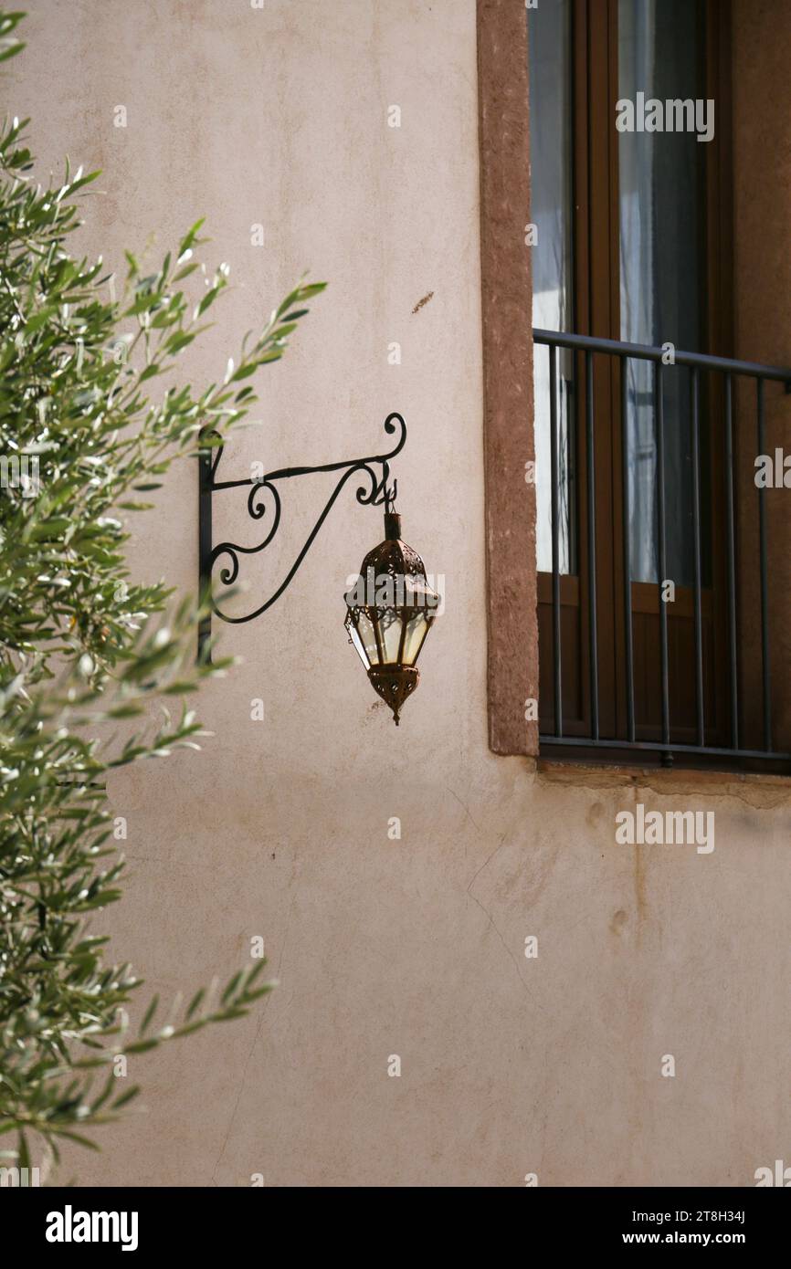 Vintage wrought iron lantern hanging on old house facade in the old ...