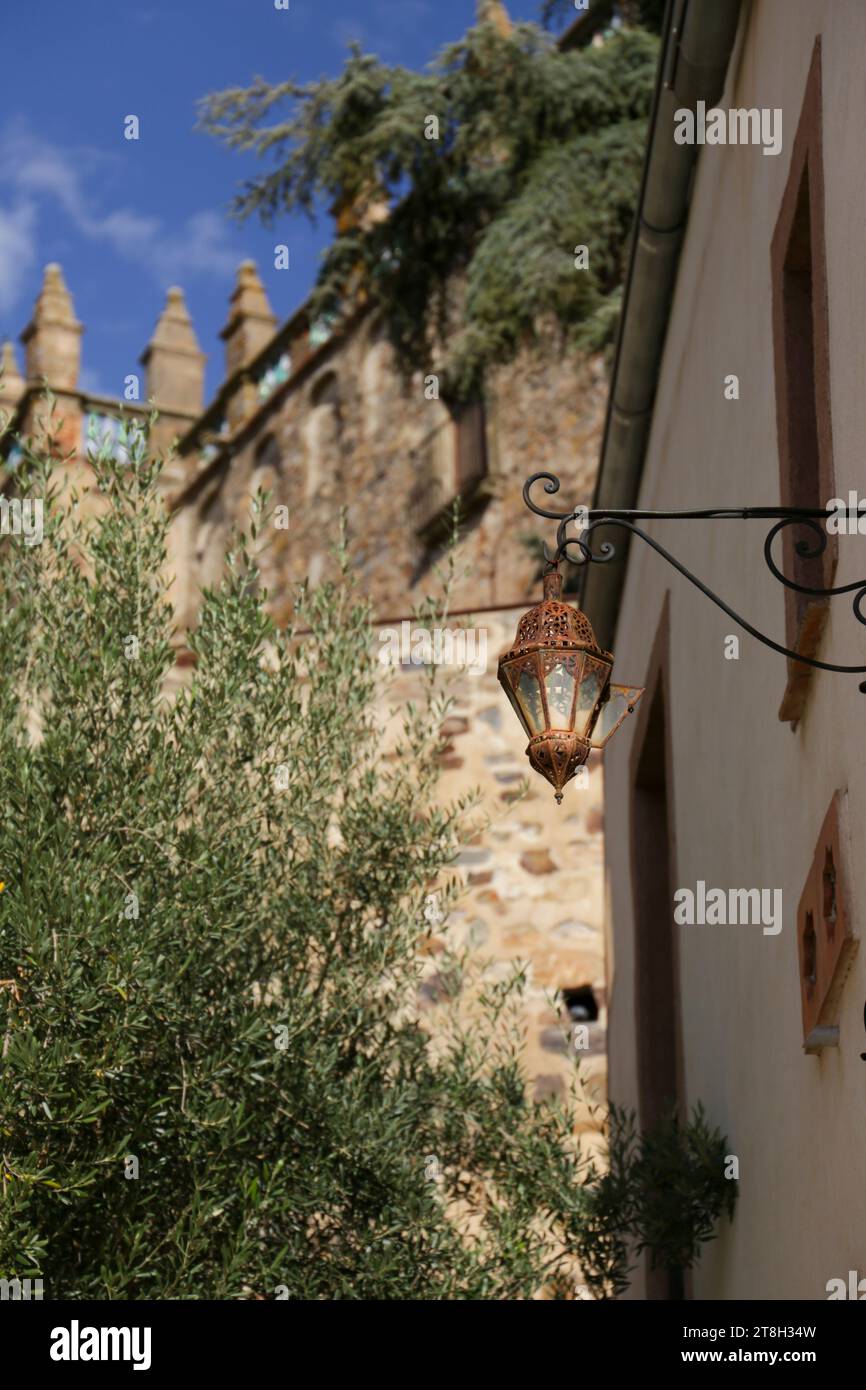 Vintage wrought iron lantern hanging on old house facade in the old ...