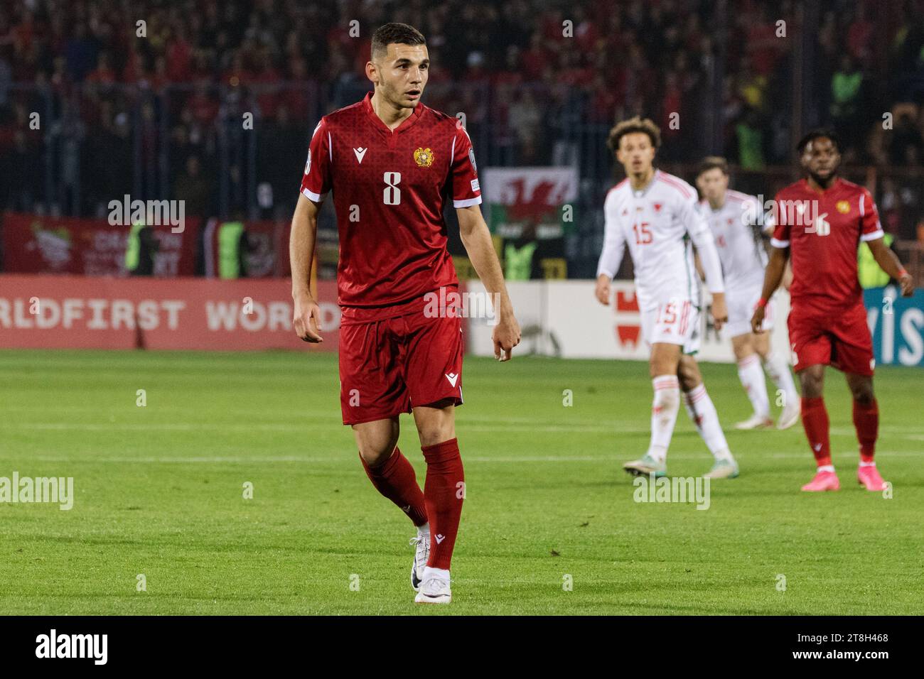 A team of soccer players walking across a lush green soccer field in ...