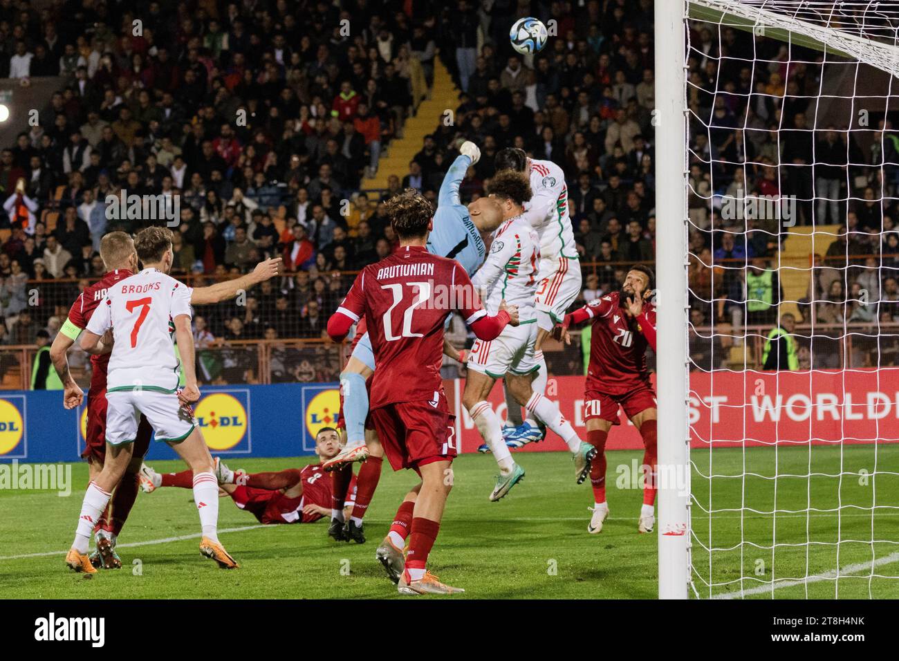 The male soccer players on a grassy field, with one in a kicking ...