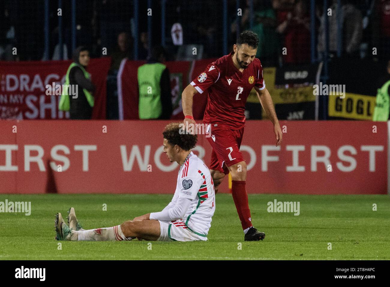 The male soccer players on a grassy field, with one in a kicking ...