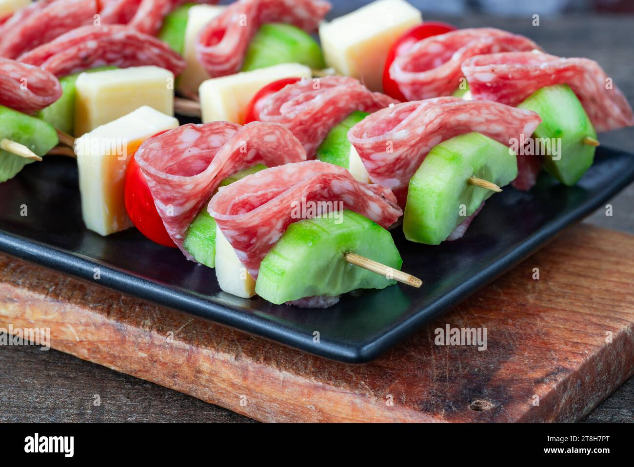 Mini Greek deli kebabs with salami, cheese, cherry tomatos and cucumber ...