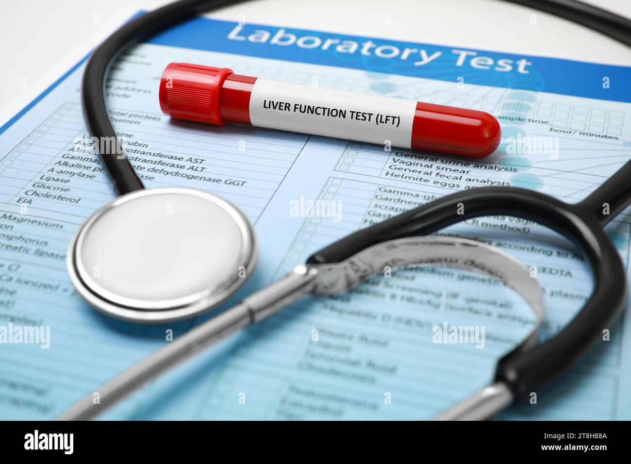 Liver Function Test. Tube with blood sample, form and stethoscope on ...