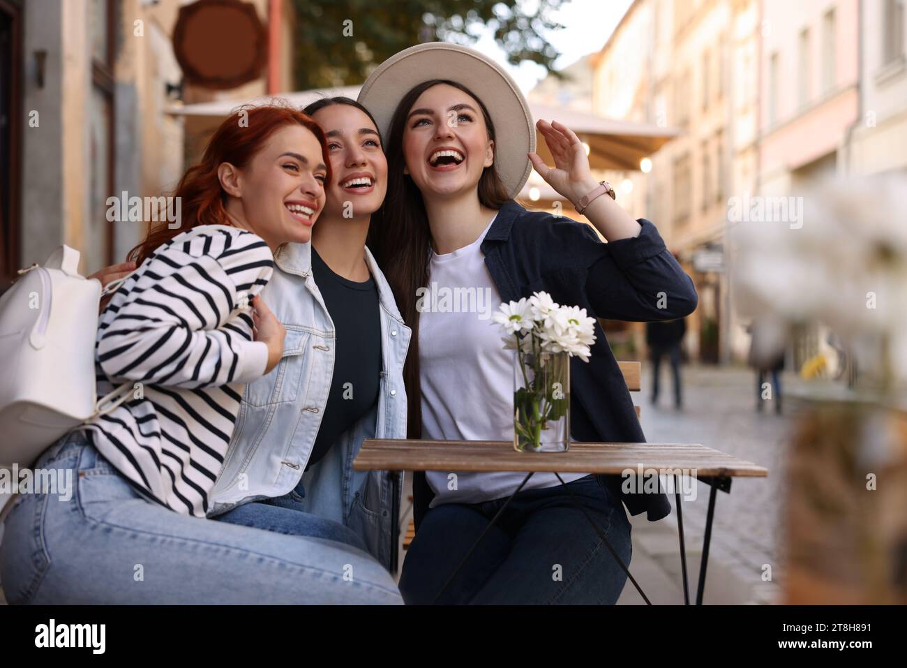 Happy friends spending time together in outdoor cafe Stock Photo - Alamy