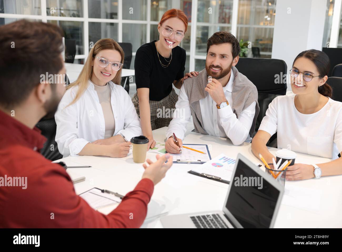 Team of employees working together in office Stock Photo - Alamy