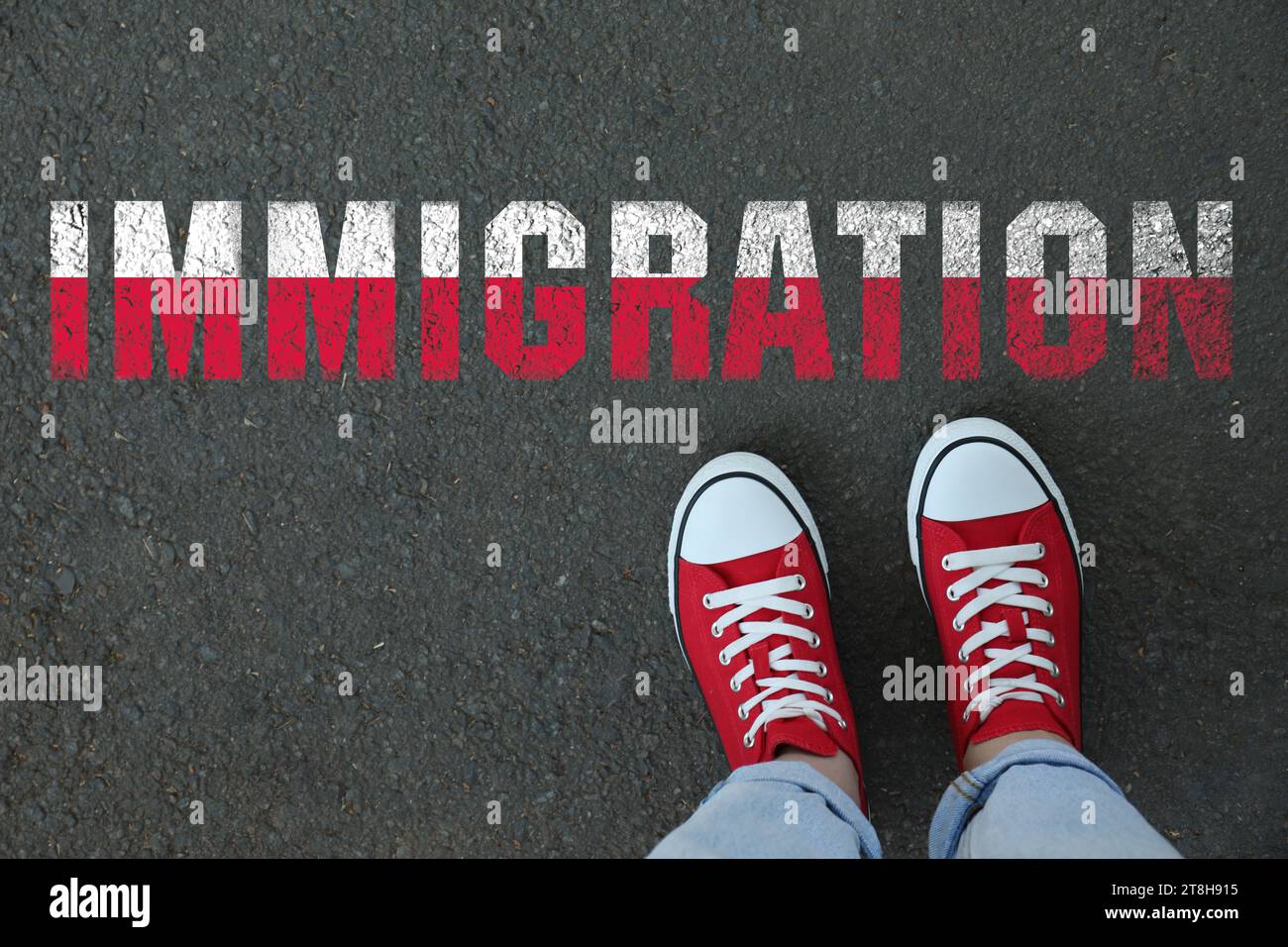 Woman standing on asphalt near word Immigration in colors of flag of ...