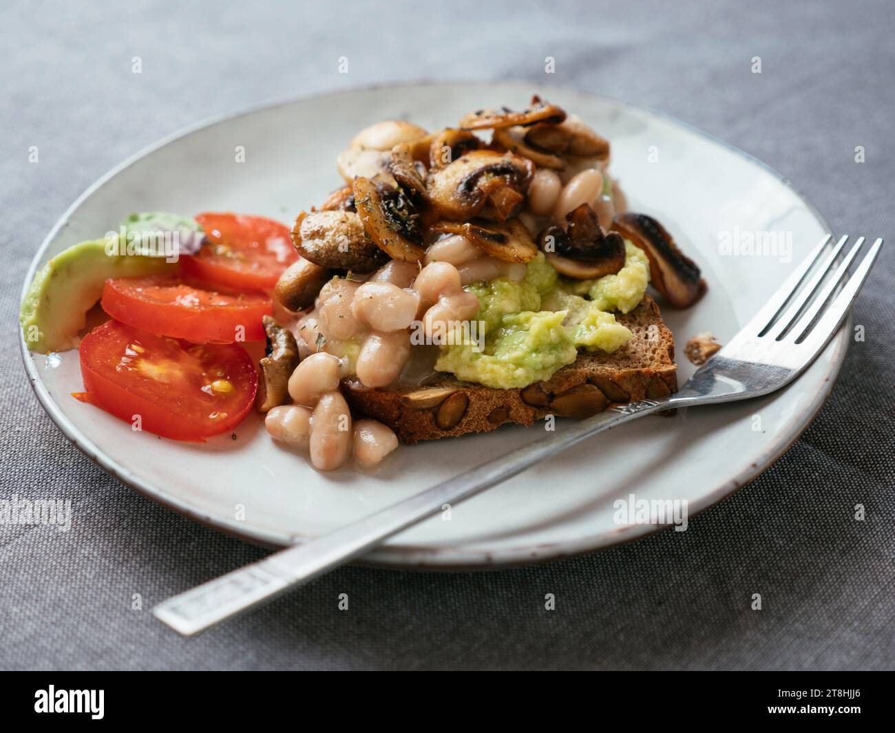 Avocado Toast with White Beans and Mushrooms Stock Photo - Alamy