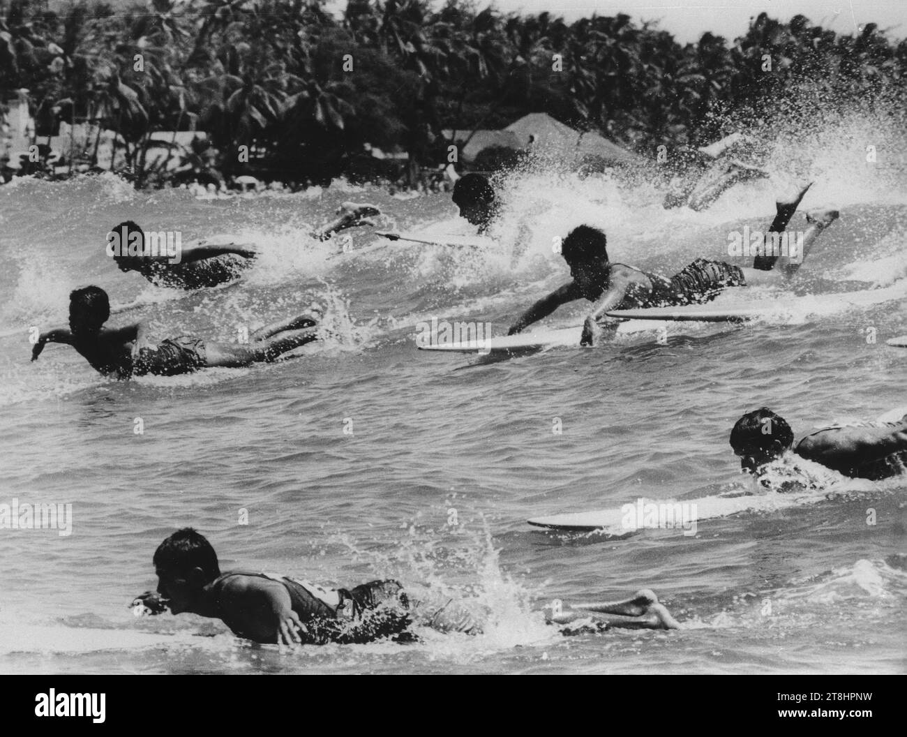 Hawaiian surfers battle the waves and the competition as they strain for the shore during the ...