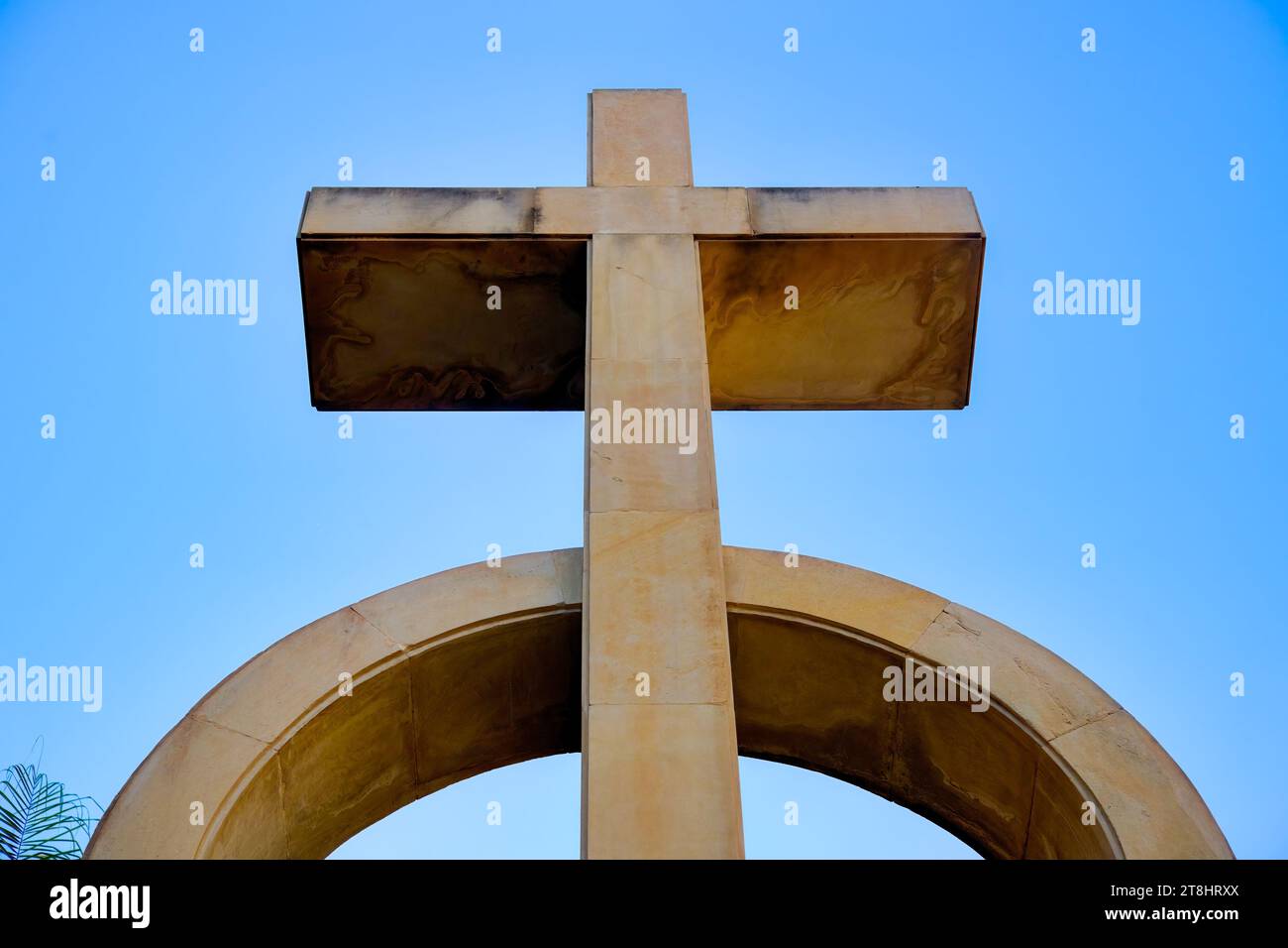 Alicante, Spain, Christian cross and arch, part of a monument in a ...