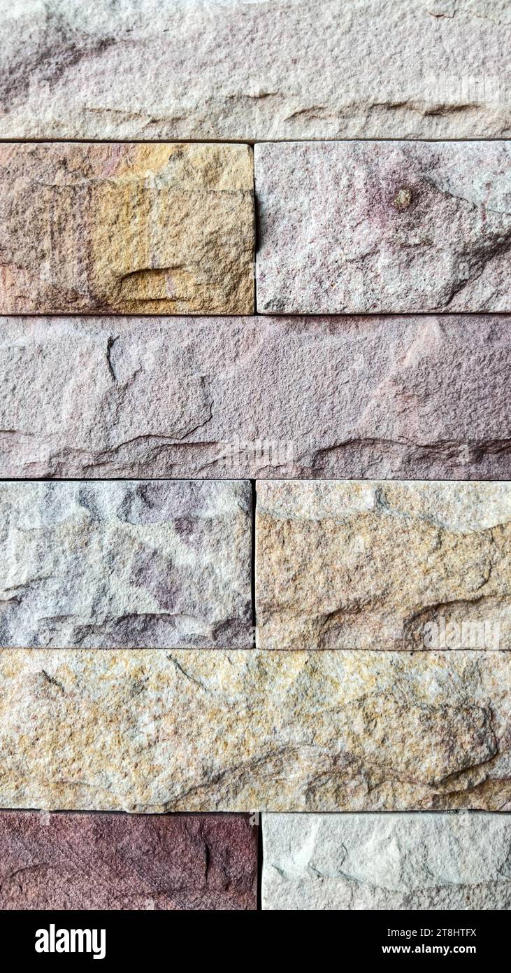 A brick wall made of natural stone, providing a visually appealing ...