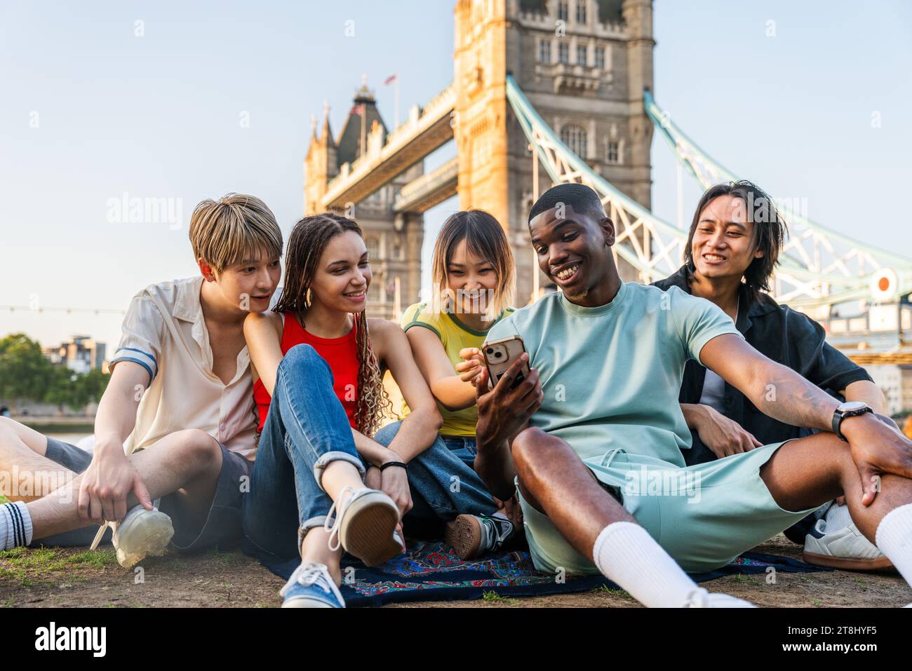 Multiracial group of happy young friends bonding in London city ...