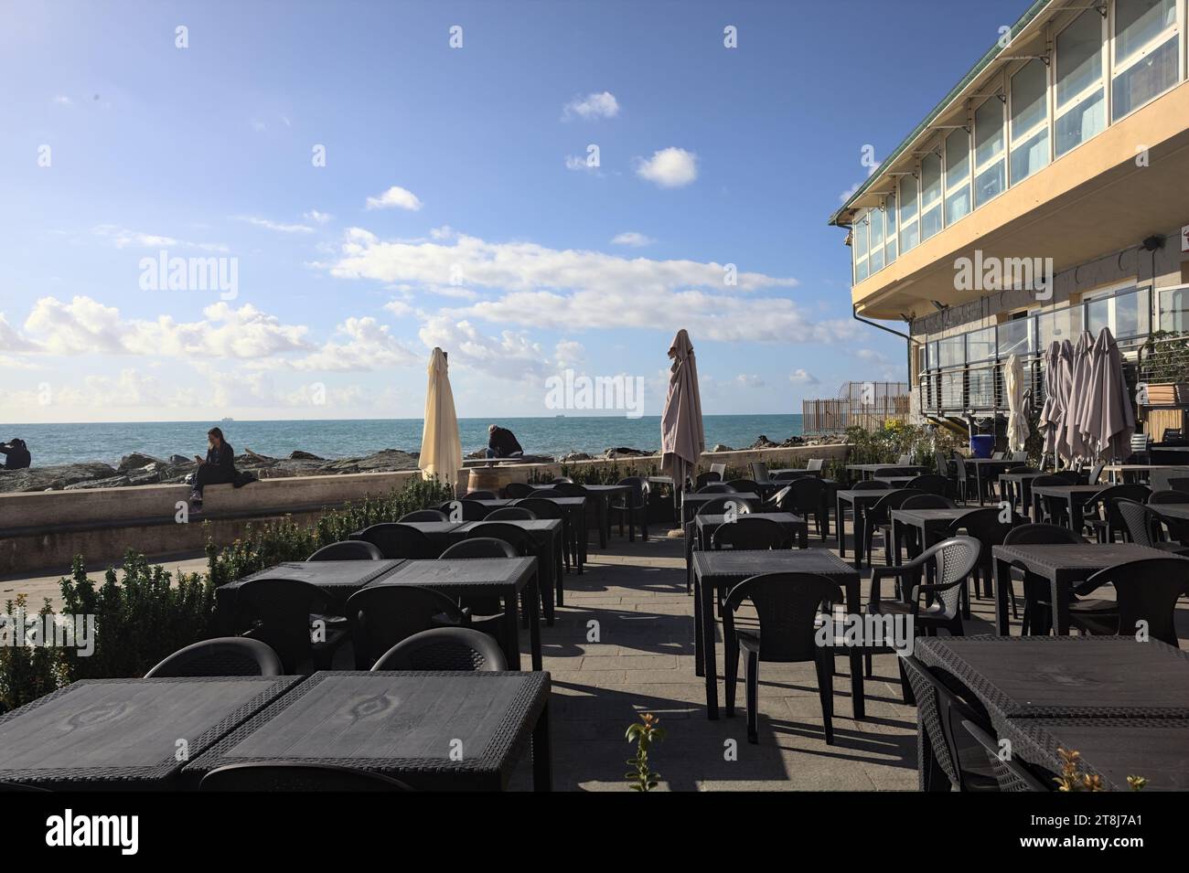 Genova, Italy - November 2023 - Tables and chairs of a restaurant on a ...