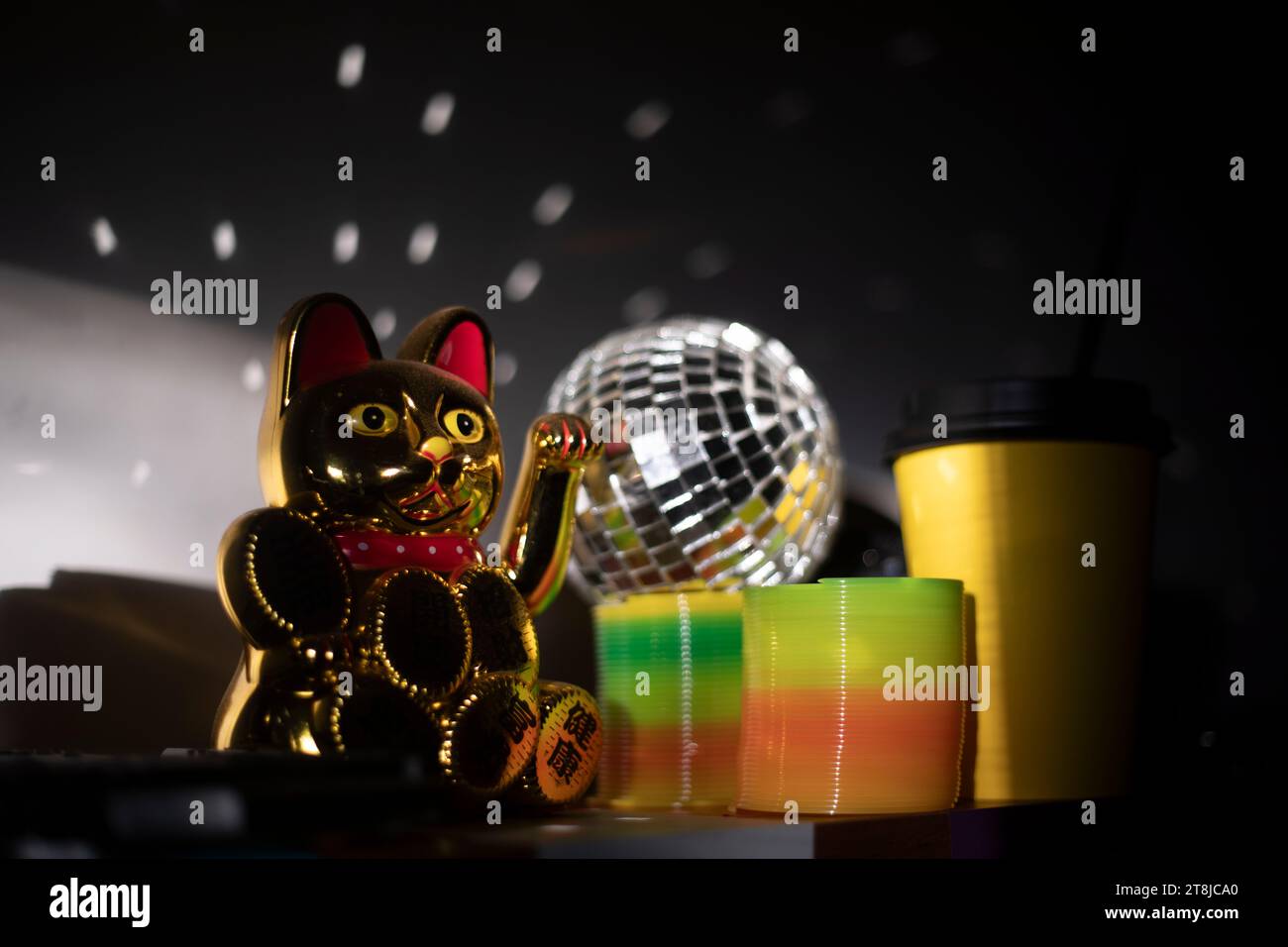 Chinese Cat Bringing Good Luck. Items on the Shelf. Glare of light on ...