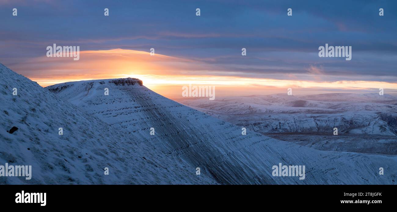 Amazing sunset light over snowy mountains in a panorama of the Brecon ...