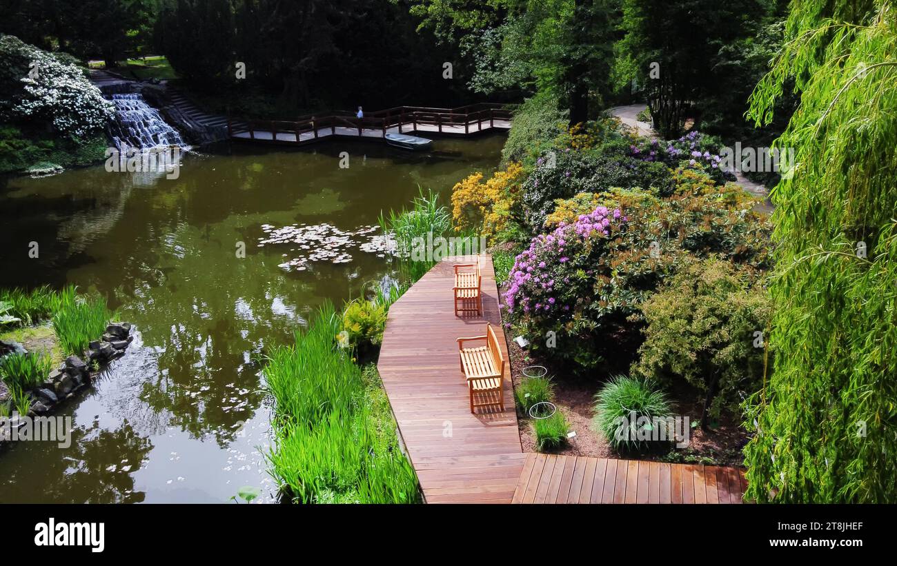 Fantastic spring view on Small artificial waterfall in pond in ...