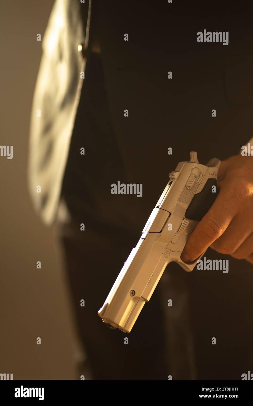 Male detective spy killer holding pistol gun in dramatic novel book ...