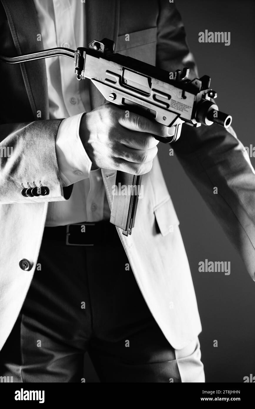 Retro secret agent with porstol revolver gun in hand in vintage crime ...