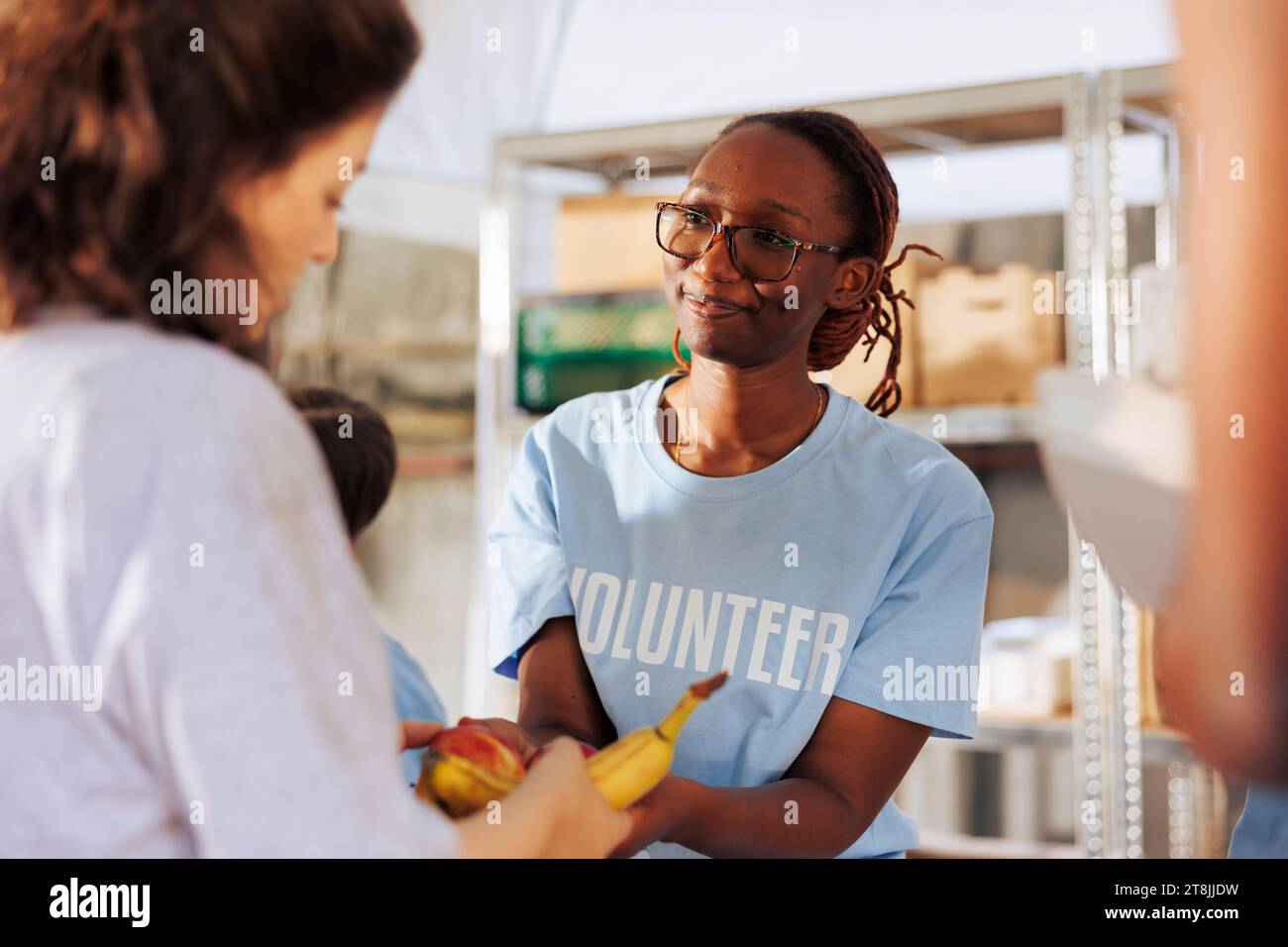 Detailed image showing african american female volunteer offering free ...