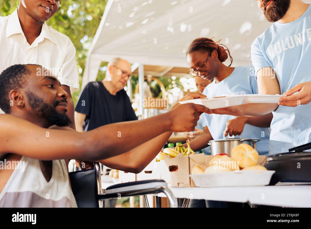 Helpful guy volunteer aids and provides free food to a poor needy ...