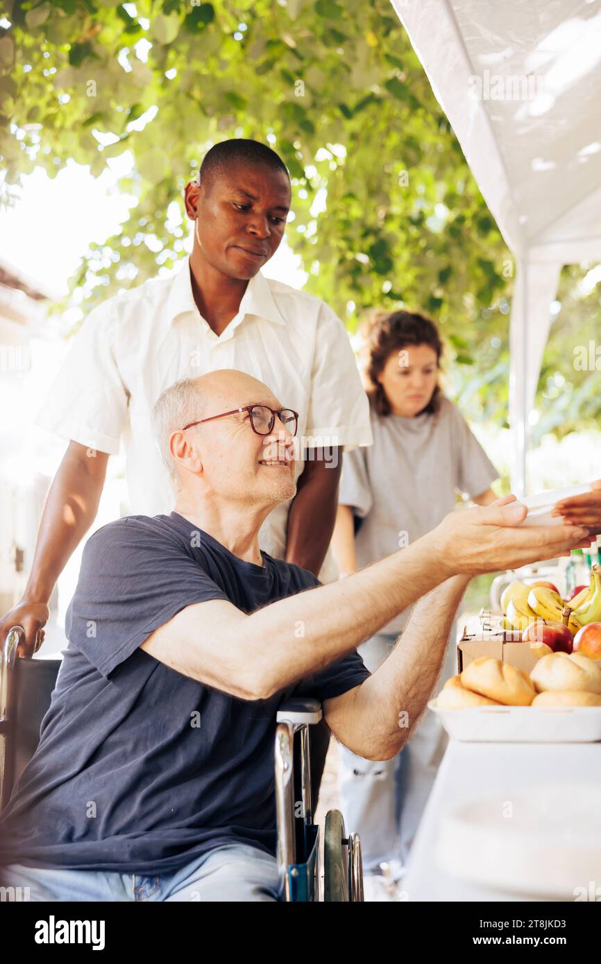 Man woman in wheelchair feeding hi-res stock photography and images - Alamy