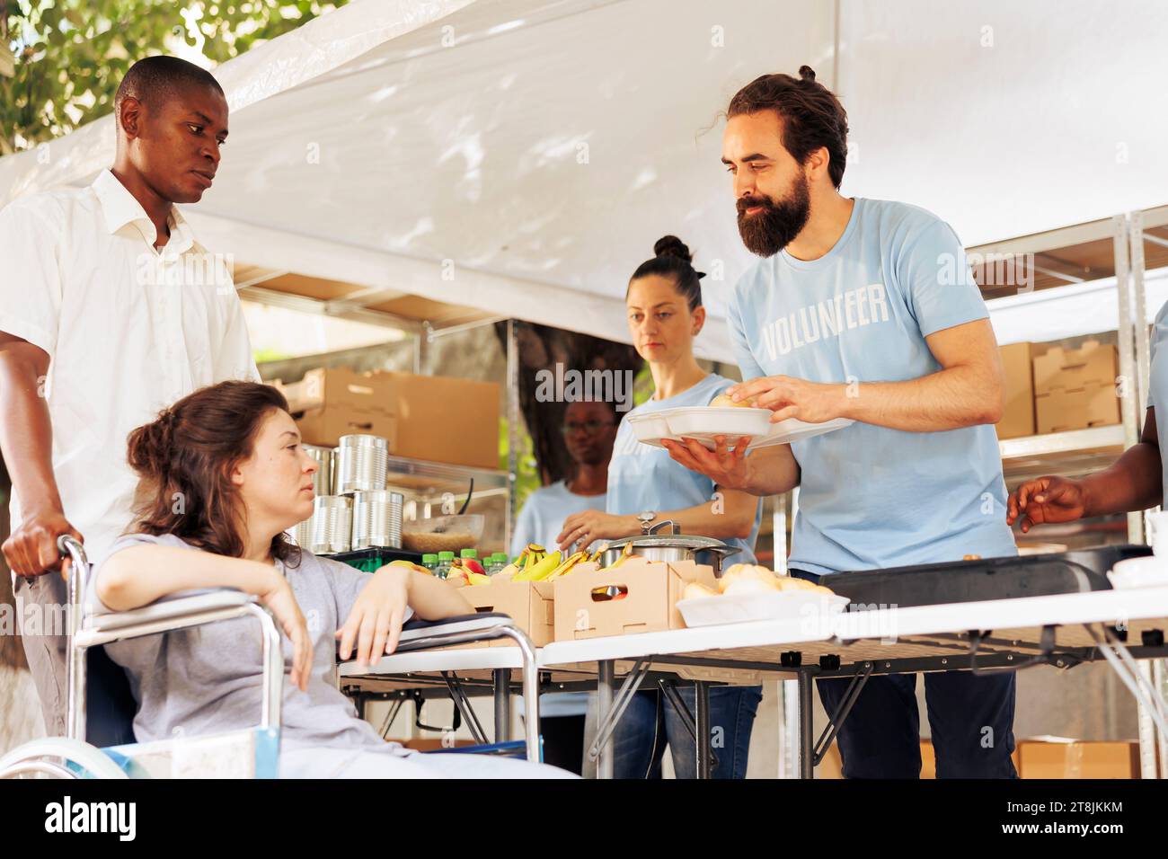 Volunteers happily provide food to diverse needy individuals, homeless ...