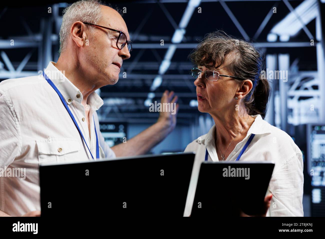 Old developers performing diagnostic assessments on server clusters to ...