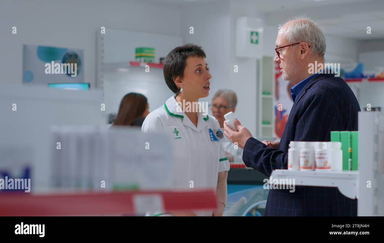 Licensed pharmacist in chemist shop offering patient heart arrhythmia ...