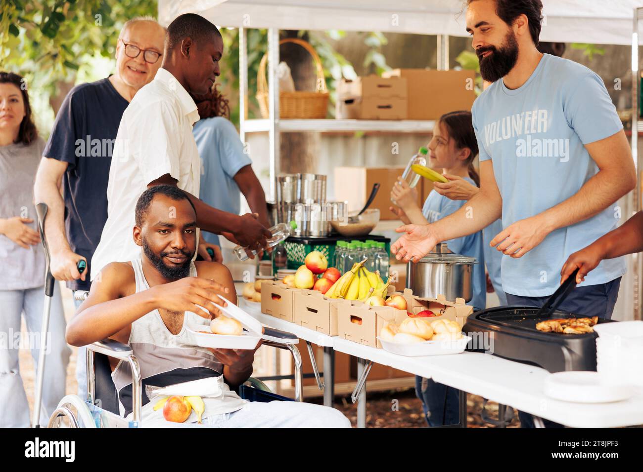 Needy african american male wheelchair user receives free food and ...