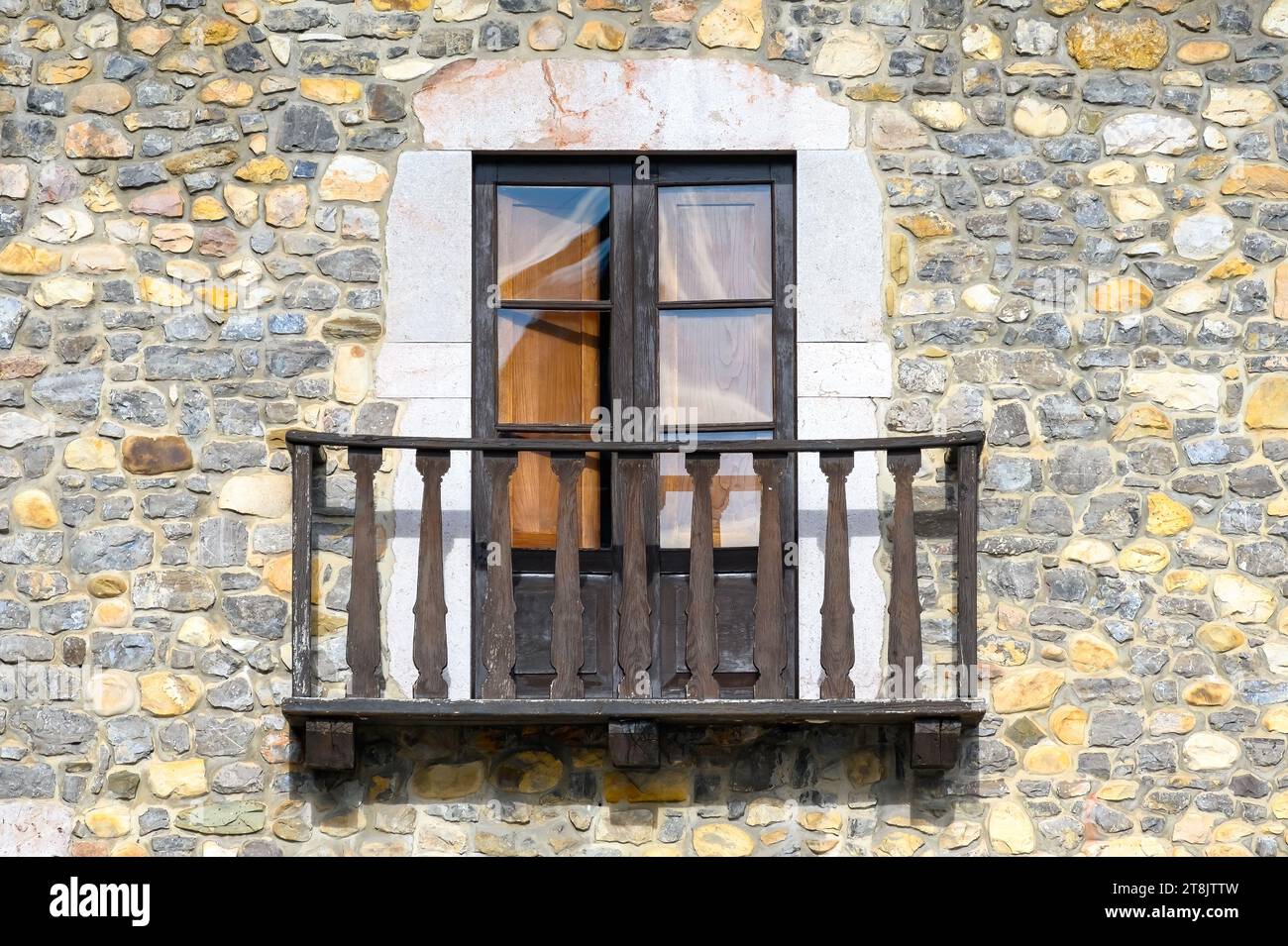ASTURIAS, SPAIN, window with balcony in a stone wall building exterior ...