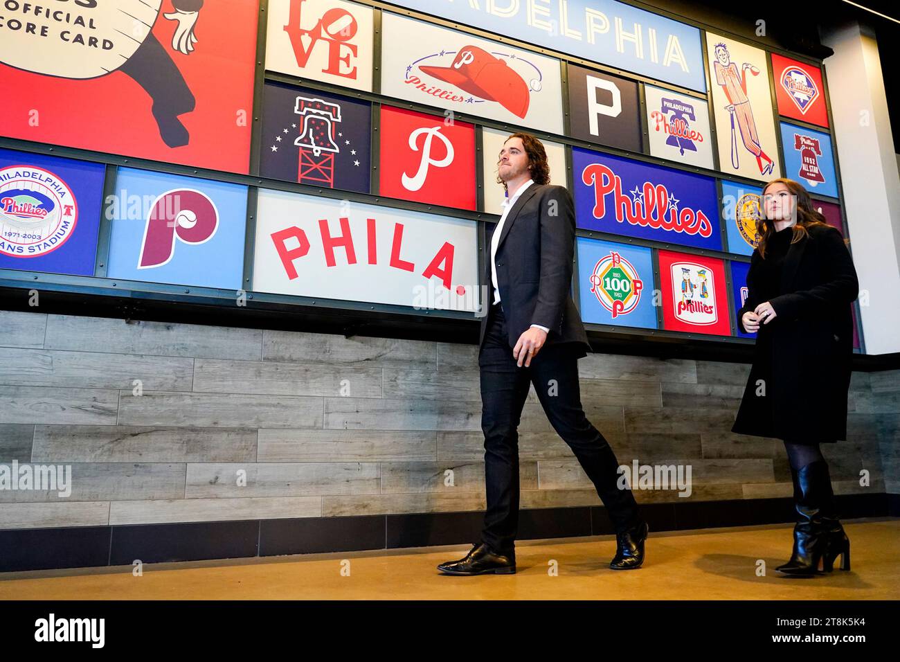 Philadelphia Phillies' Aaron Nola, left, heads to the press conference ...