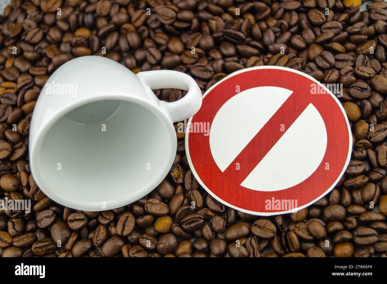 roasted coffee beans and cup with prohibition sign Stock Photo - Alamy