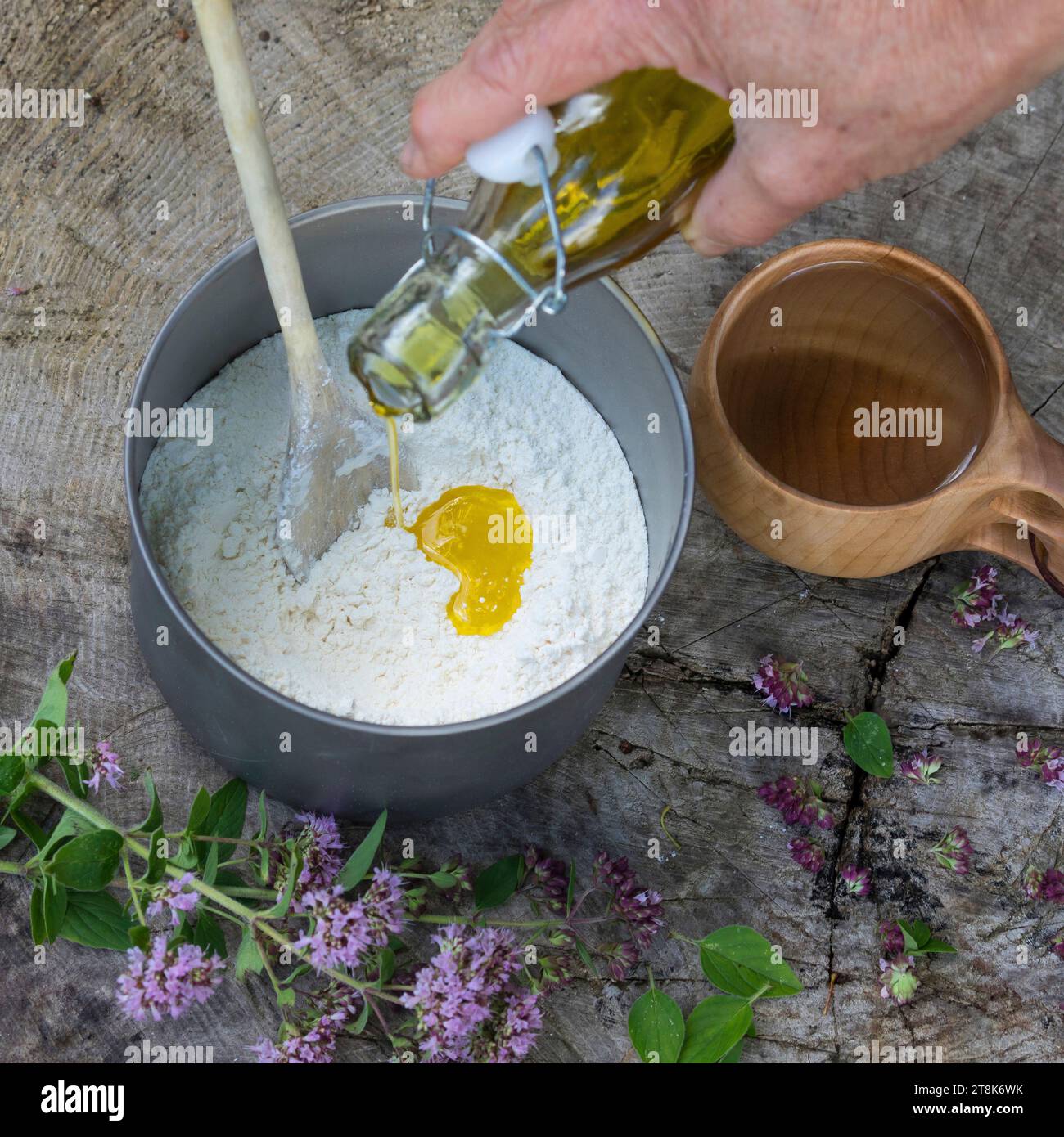 making of bannock, is baked on open fire, flour, baking powder and oil ...