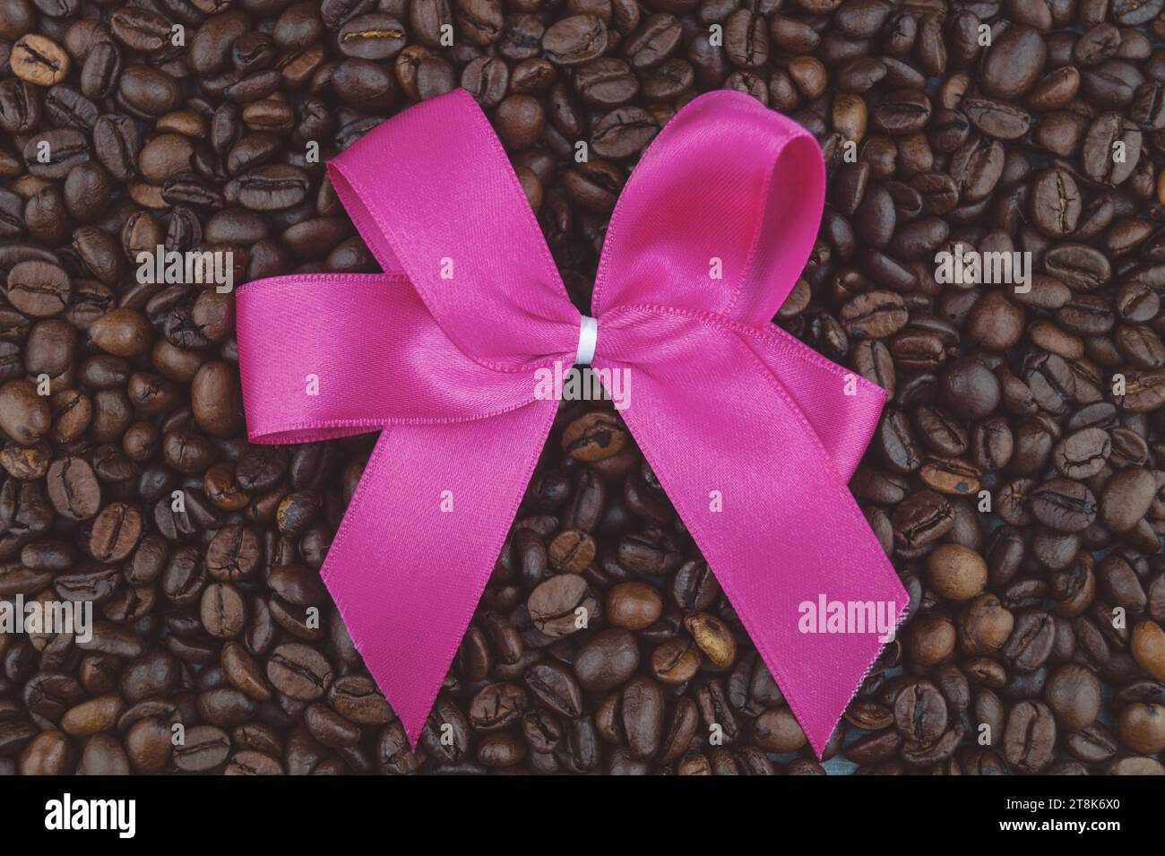 roasted coffee beans with pink ribbon Stock Photo - Alamy
