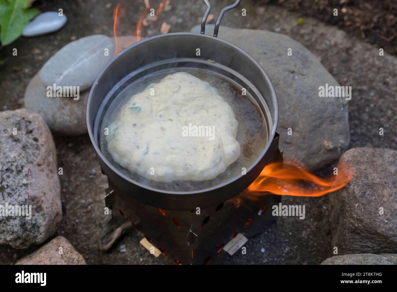 making of bannock, is baked on open fire, bread dough is formed and ...