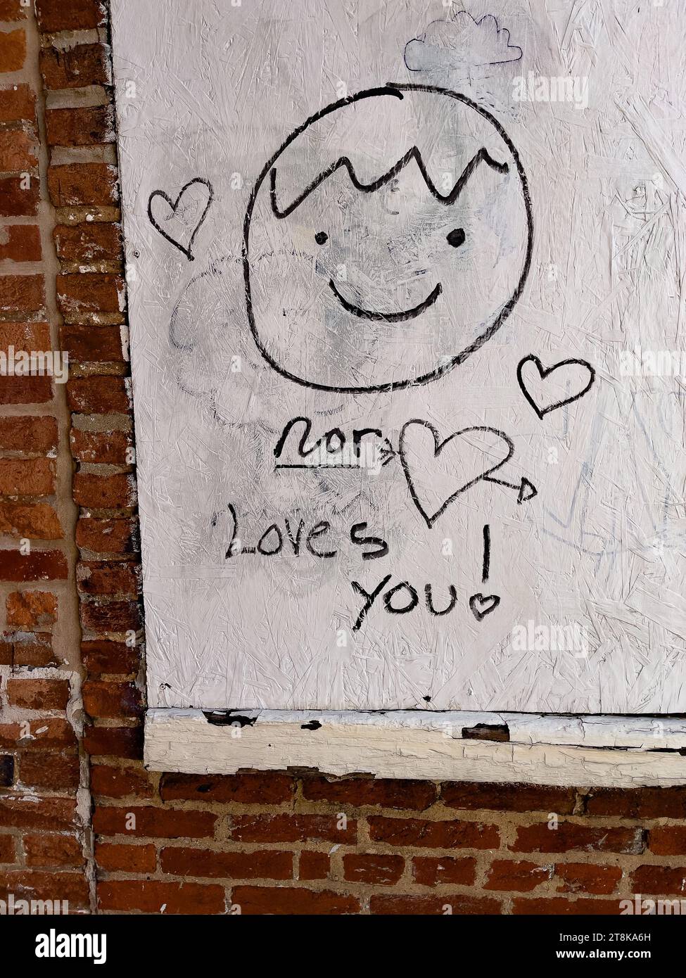 Back alley brick wall graffiti. Smiley face. Heart w arrow. Nor Loves ...