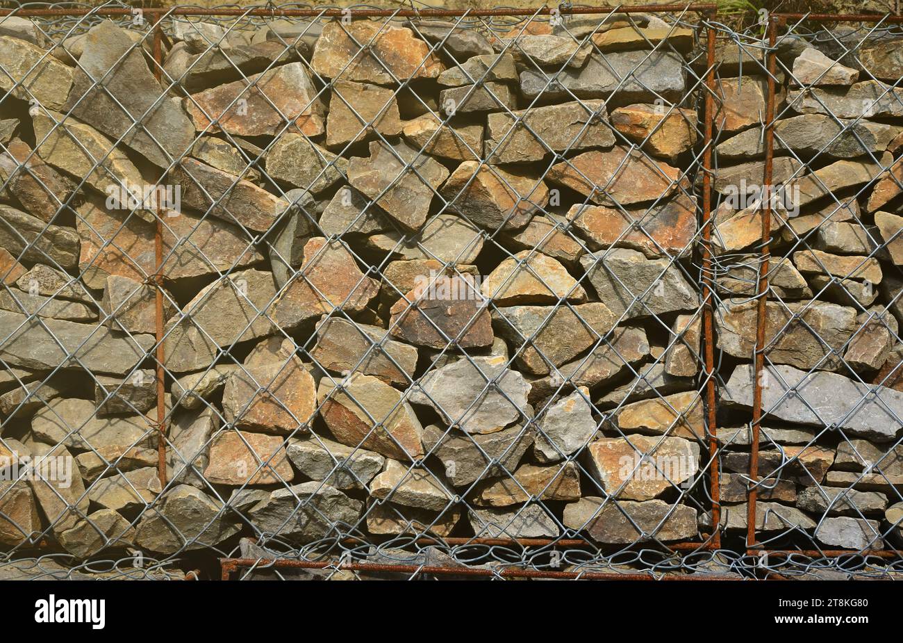Photo of several gabions. The mesh cells of the cubic form are filled ...