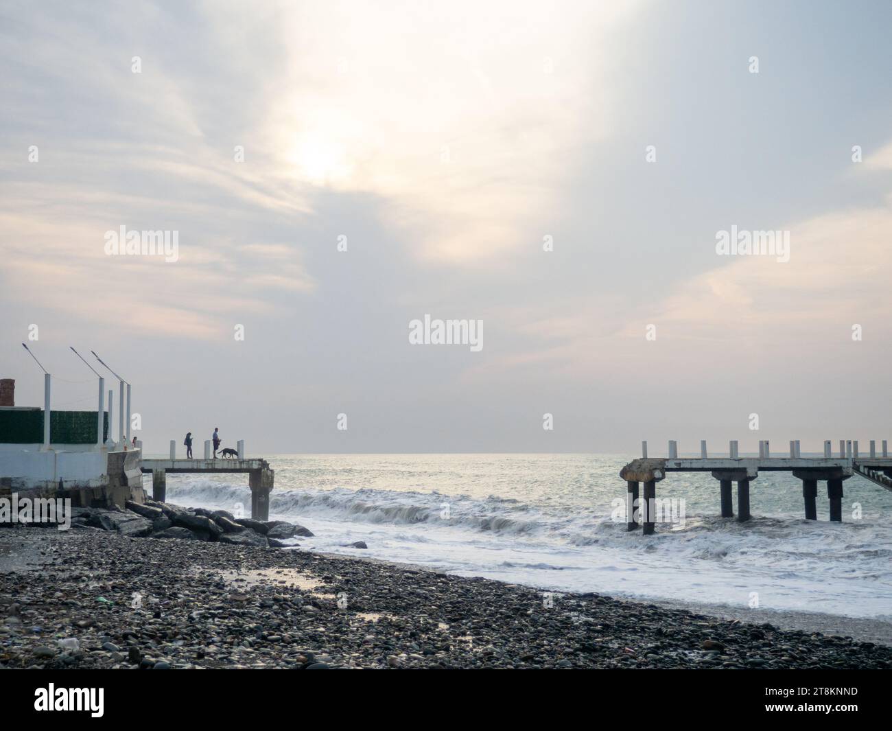 Destroyed pier under the waves. Bad weather at sea. Beautiful seashore ...