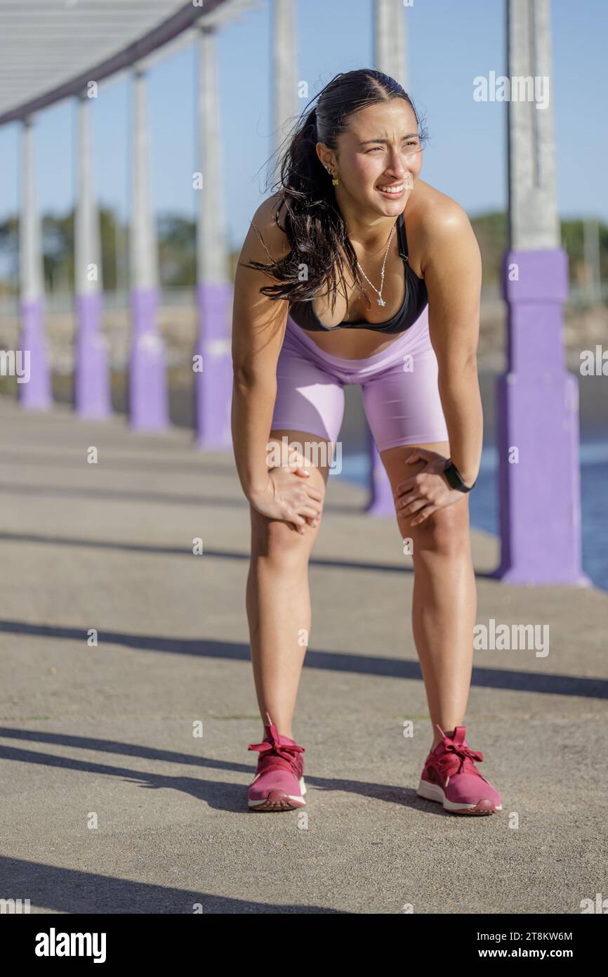 Sport woman tired and exhausted breathing and cooling down after ...