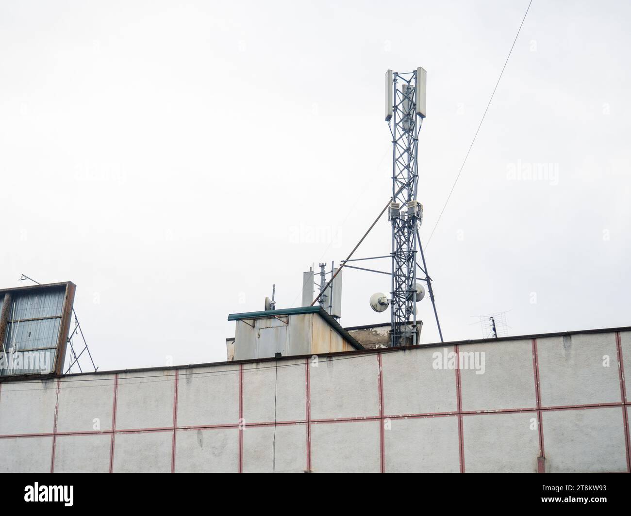 Cell phone tower on the roof of a building. The concept of abundant ...